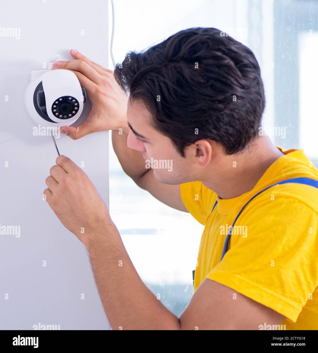 The contractor installing surveillance cctv cameras in office Stock ...