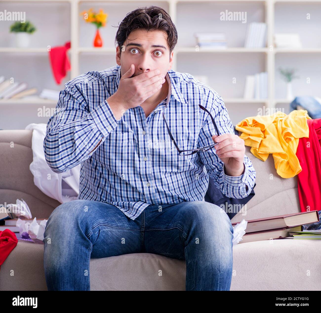 The young man working studying in messy room Stock Photo - Alamy