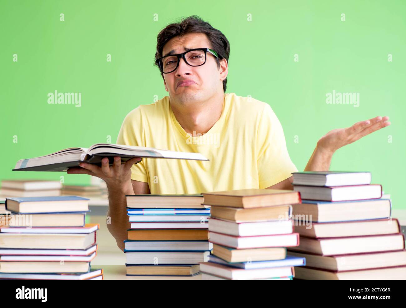 The student with too many books to read before exam Stock Photo - Alamy