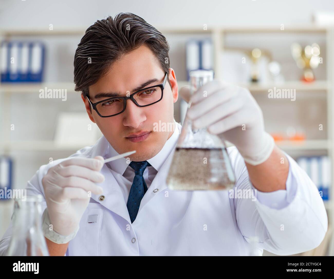 Young researcher scientist doing a water test contamination experiment ...