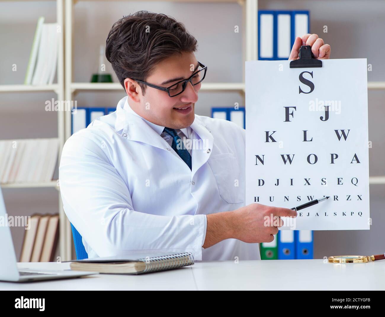The doctor optician with letter chart conducting an eye test check ...