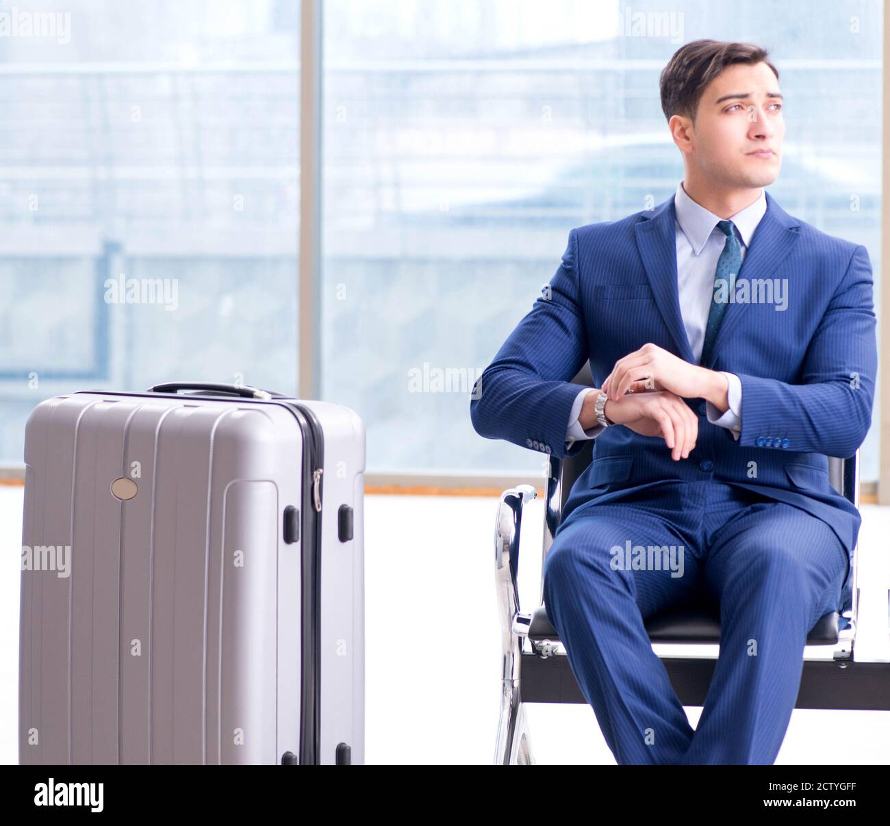 Businessman waiting at the airport for his plane in business class ...