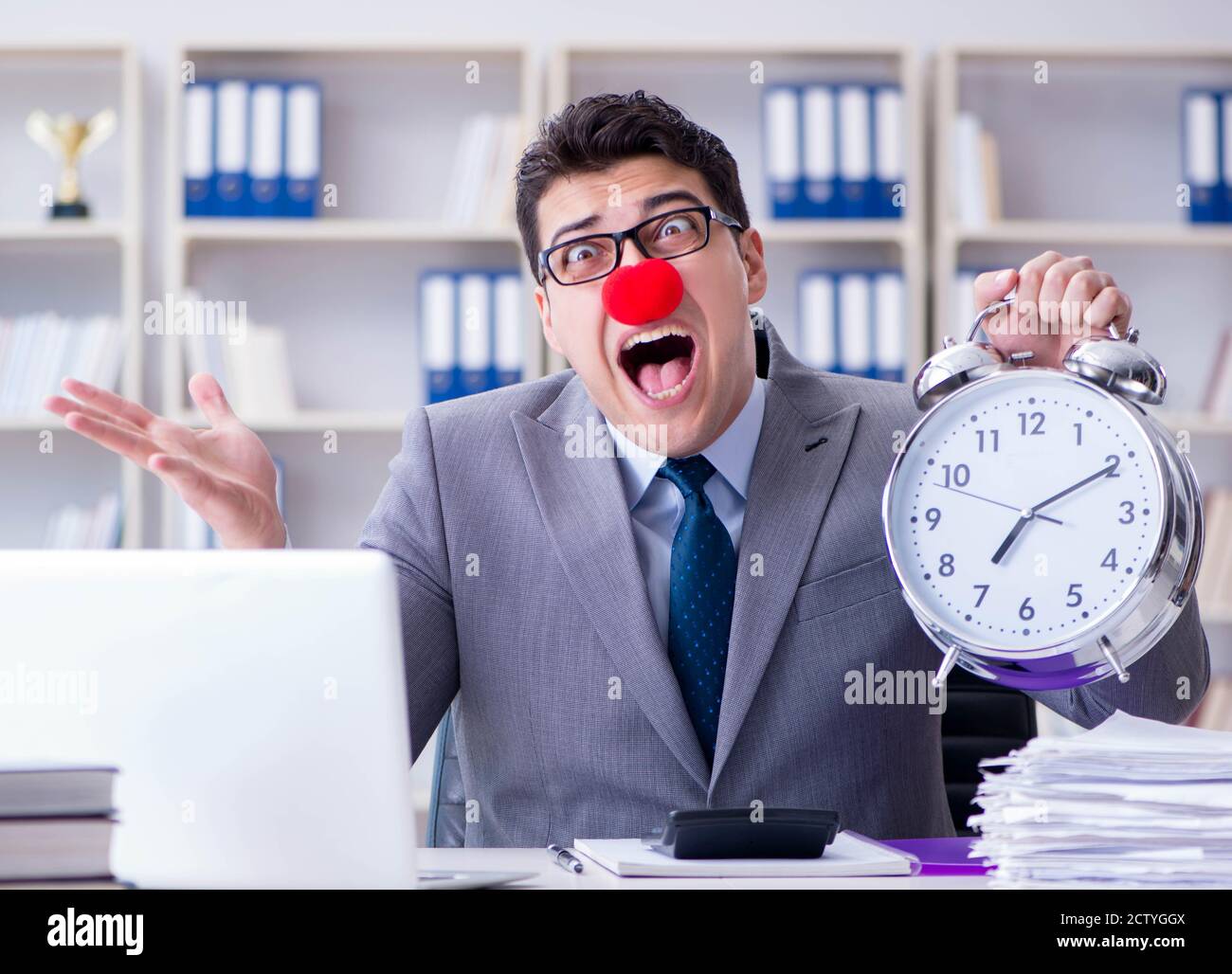 The clown businessman with alarm clock missing dieadline Stock Photo ...