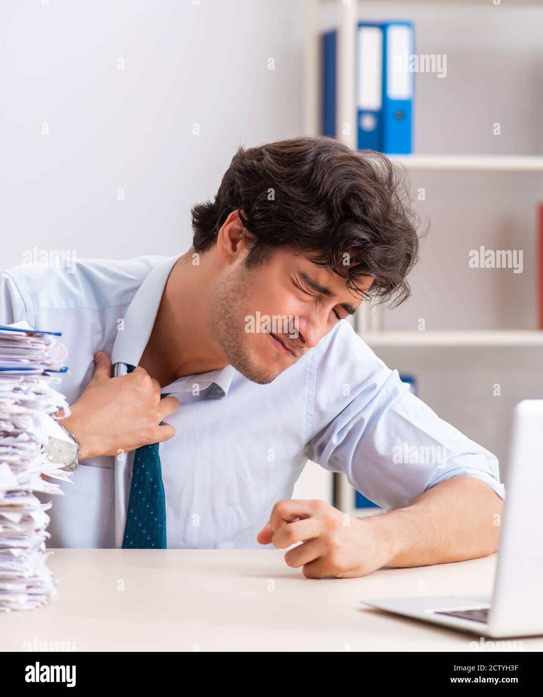 The overloaded busy employee with too much work and paperwork Stock ...