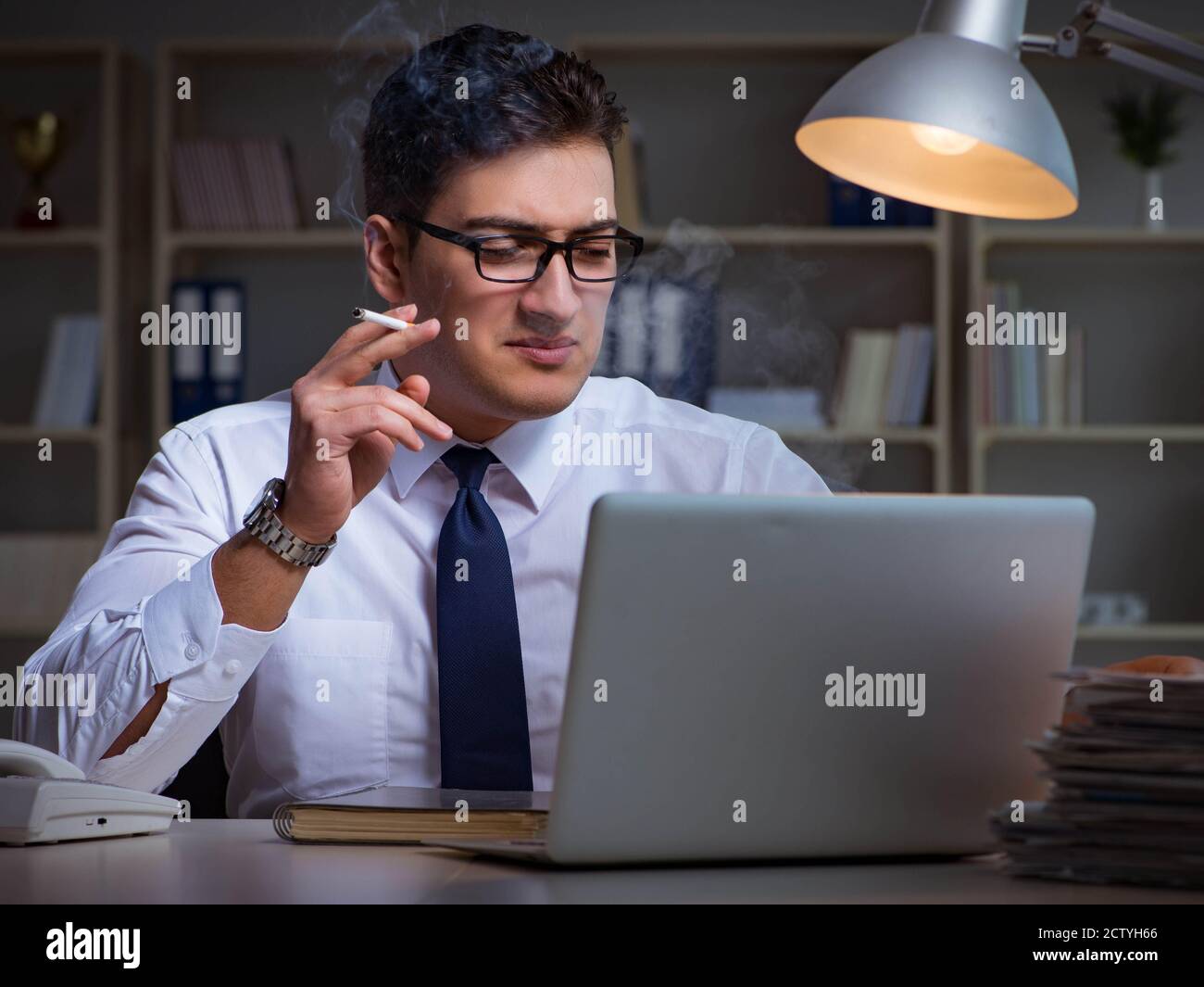 Businessman under stress smoking in office hi-res stock photography and ...
