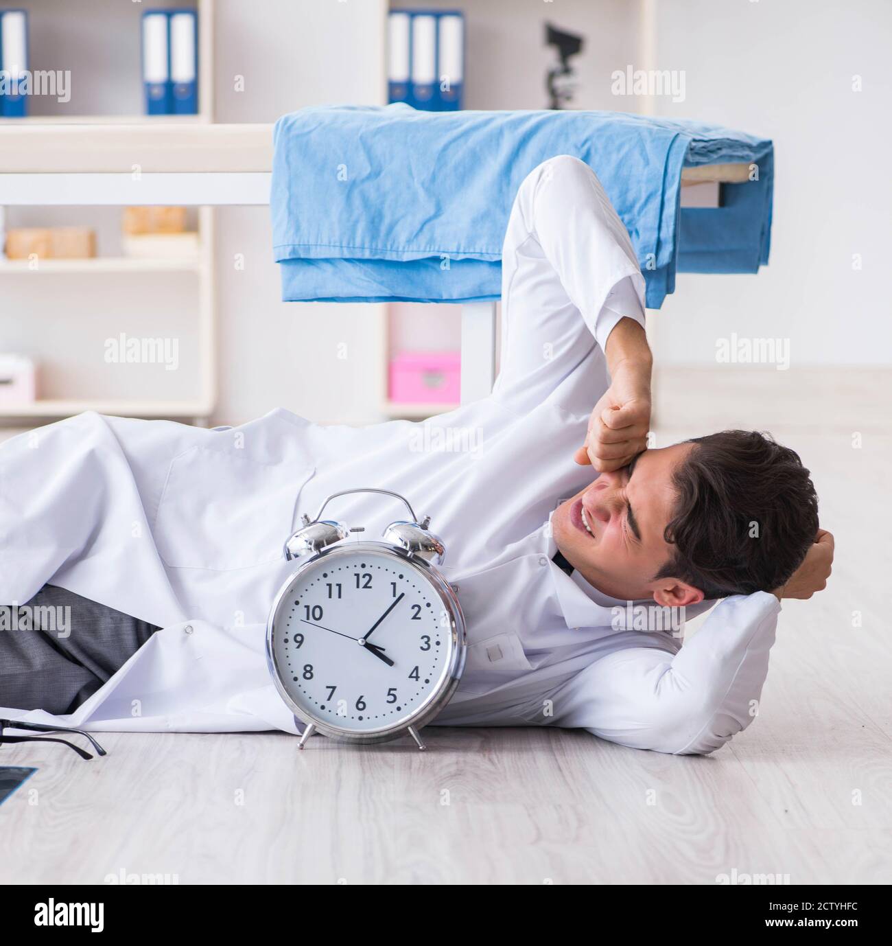 The sleepy doctor tired after long night shift Stock Photo - Alamy