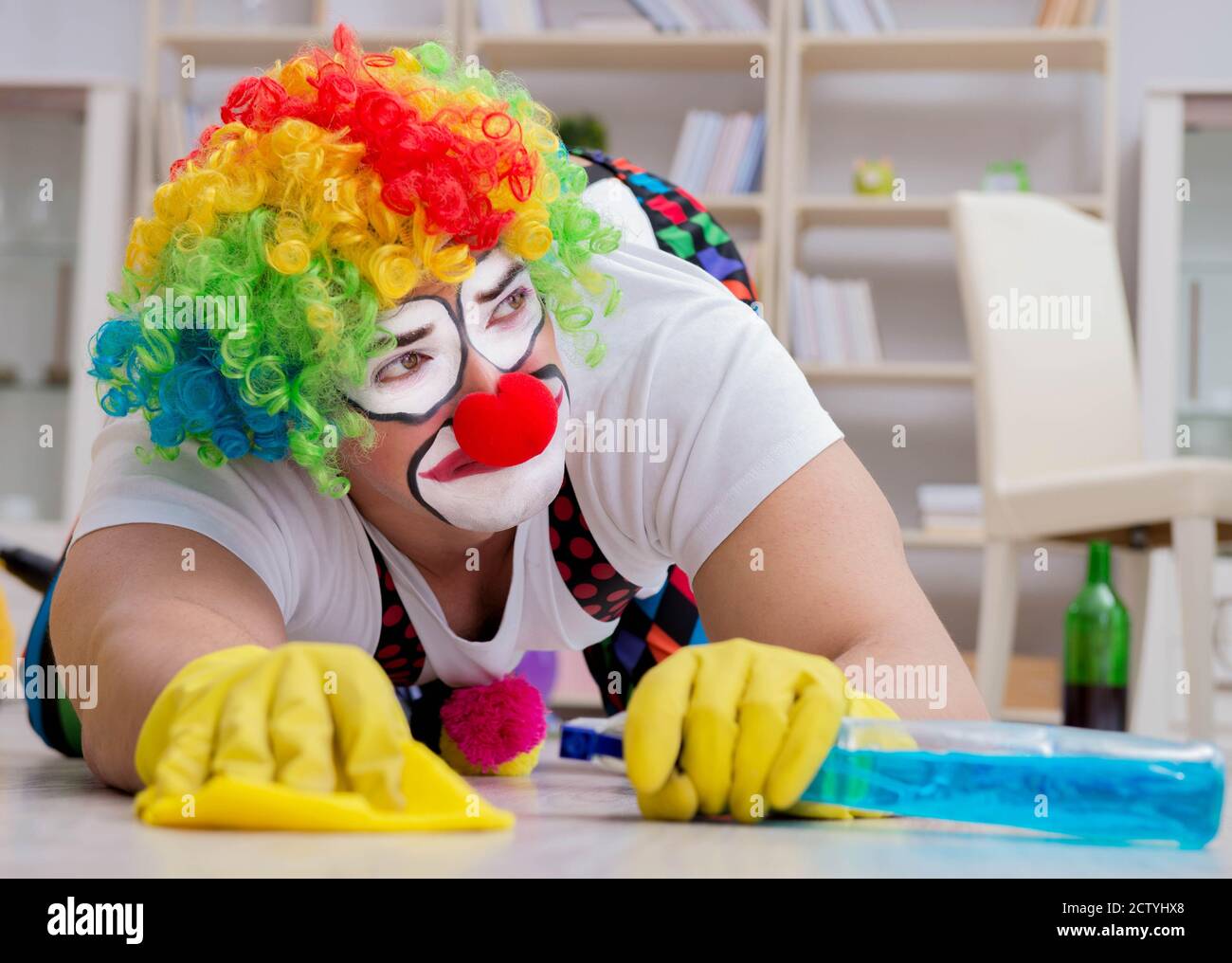 Funny clown doing cleaning at home Stock Photo - Alamy
