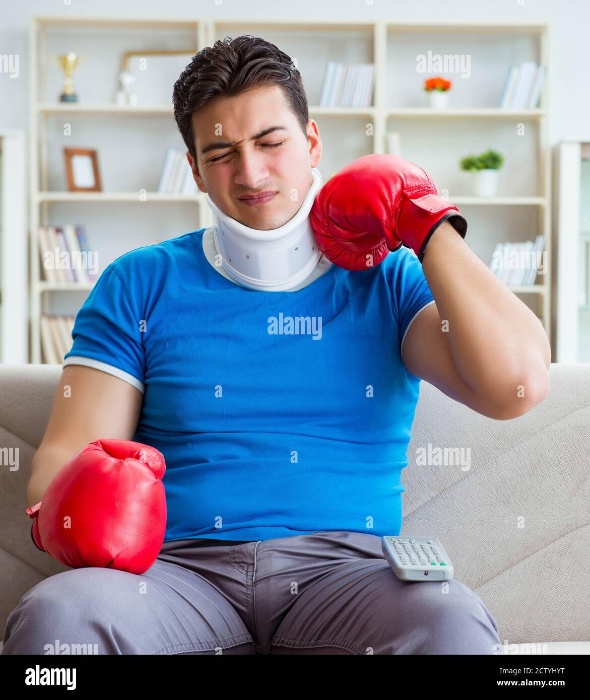 The man with neck injury watching boxing at home Stock Photo - Alamy