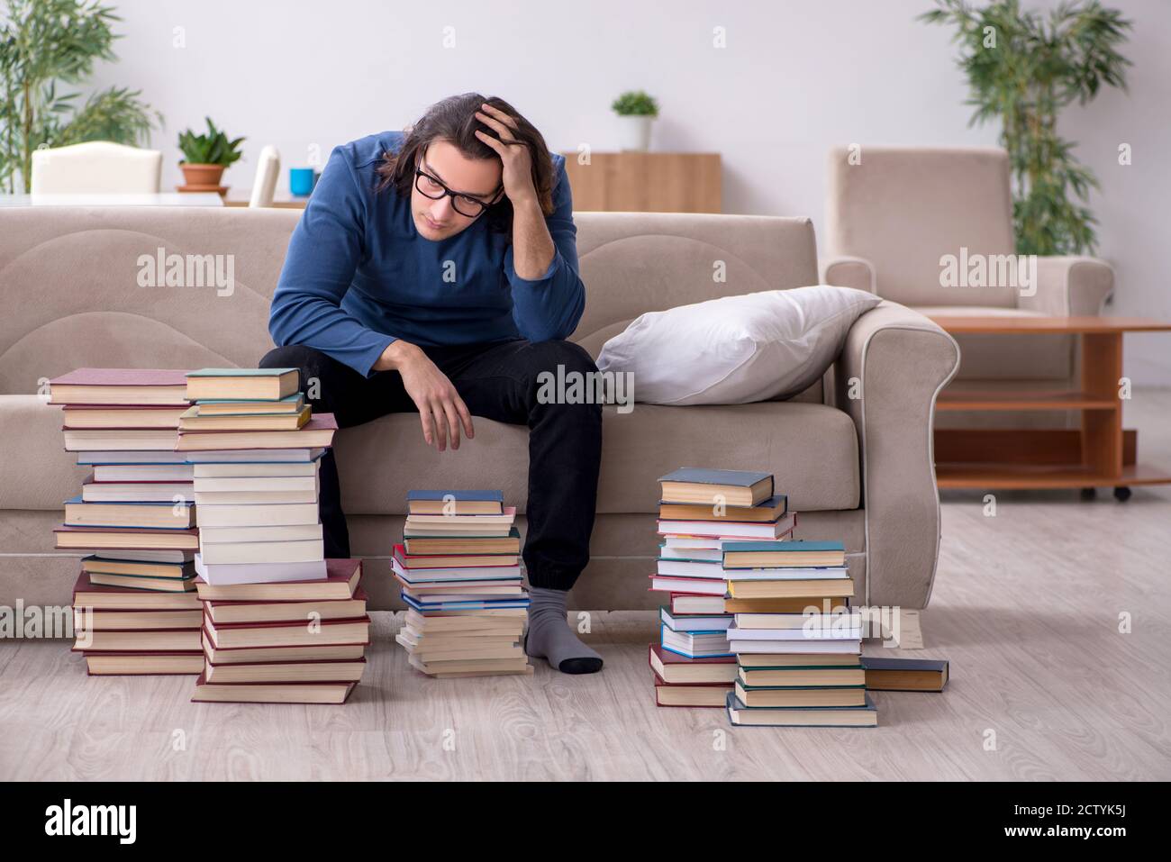 Young student preparing for exams at home Stock Photo - Alamy