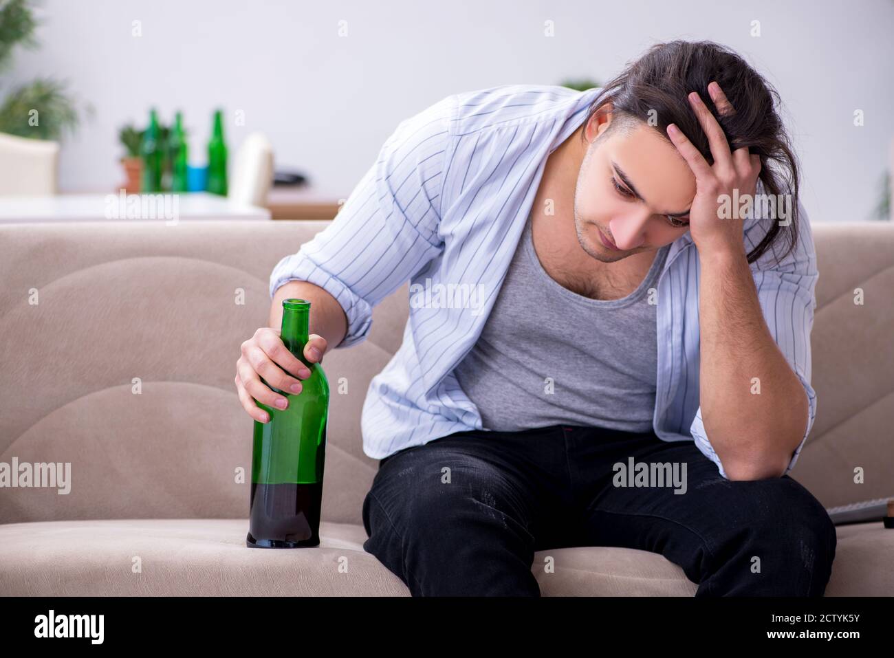 Male alcoholic drinking wine at home Stock Photo - Alamy