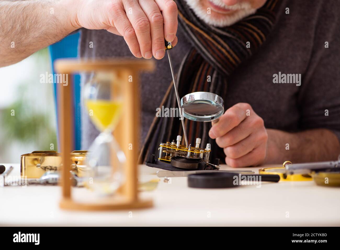 Old watchmaker working in the workshop Stock Photo - Alamy