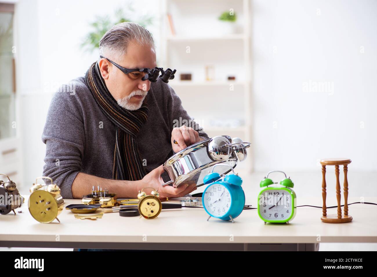 Old watchmaker working in the workshop Stock Photo - Alamy