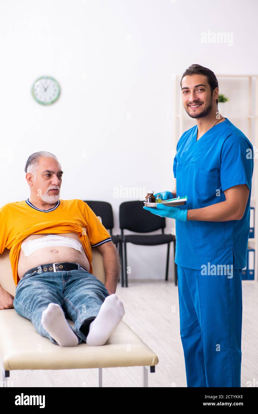 Old man visiting male doctor Stock Photo - Alamy