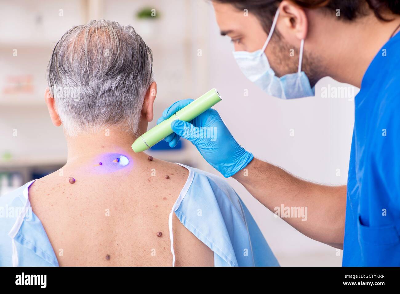 Old man visiting male doctor dermatologist Stock Photo - Alamy