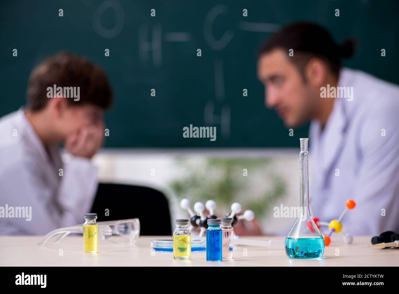 Young chemistry teacher and schoolboy in classroom Stock Photo - Alamy