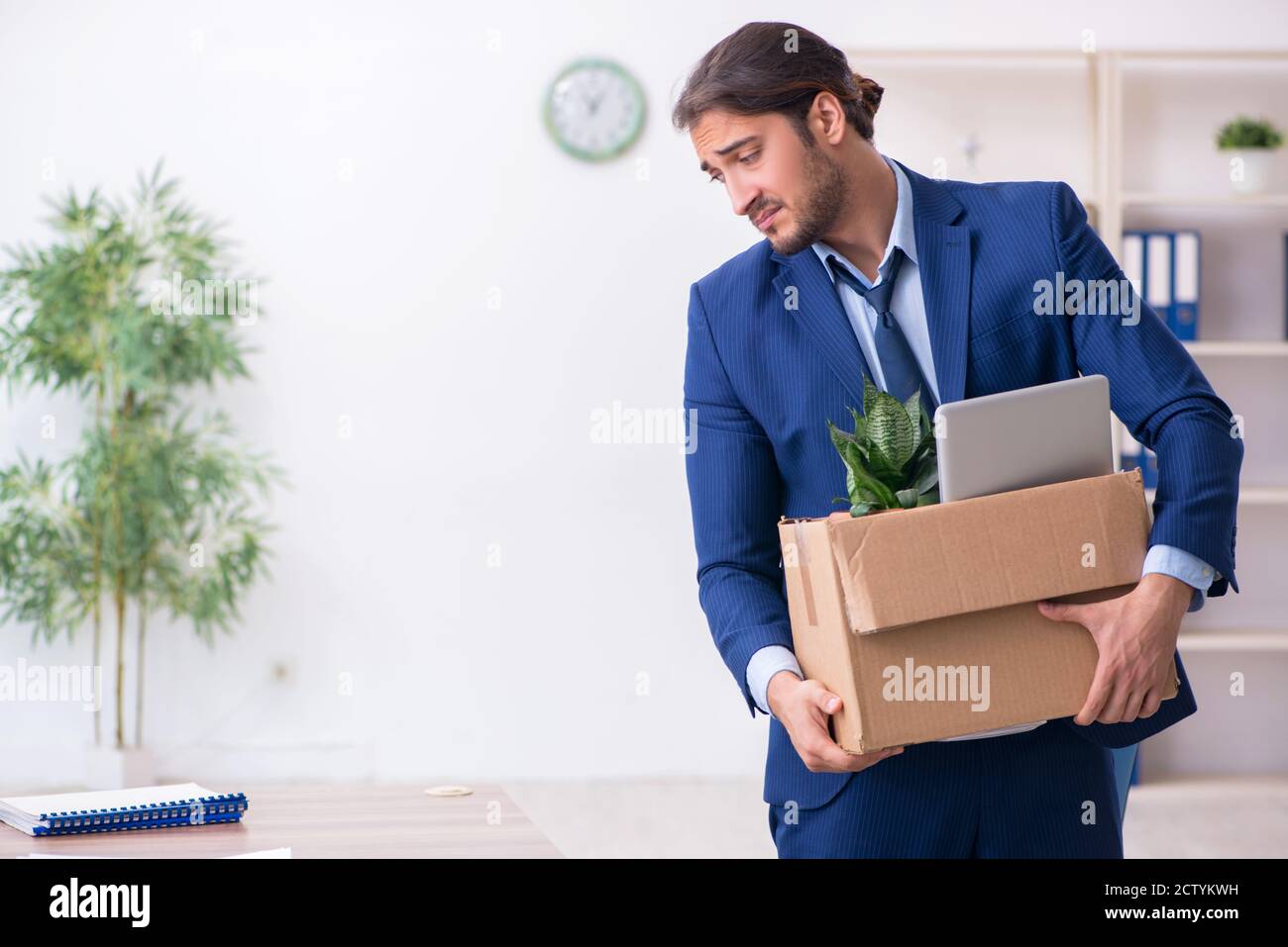 Young man being fired from his workplace Stock Photo - Alamy