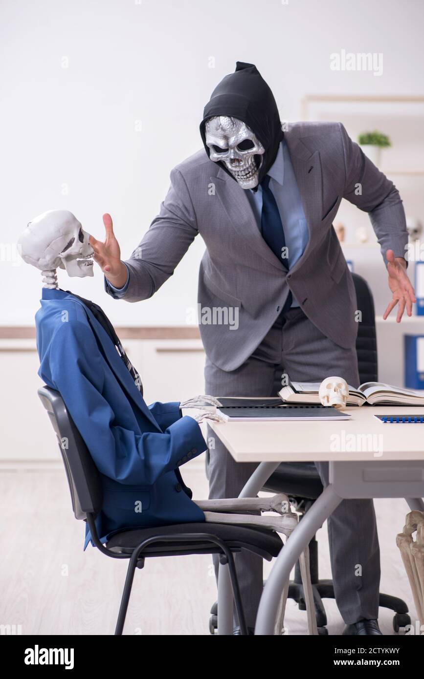 Funny business meeting with the devil and skeletons Stock Photo - Alamy