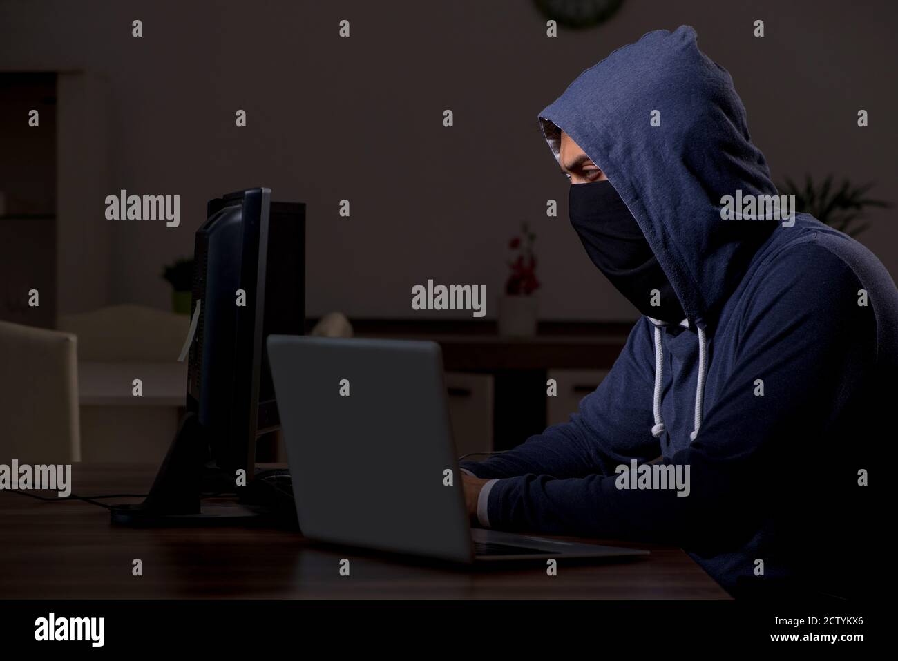 Male hacker hacking security firewall late in the office Stock Photo ...