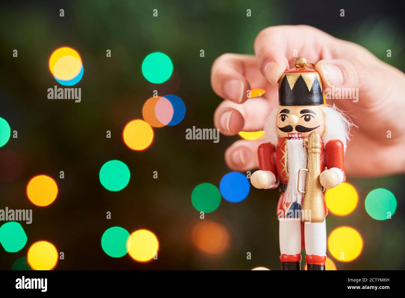 Hand of a woman placing a traditional red and white Christmas ...