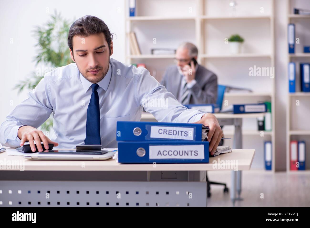 The two accountants working in the office Stock Photo - Alamy