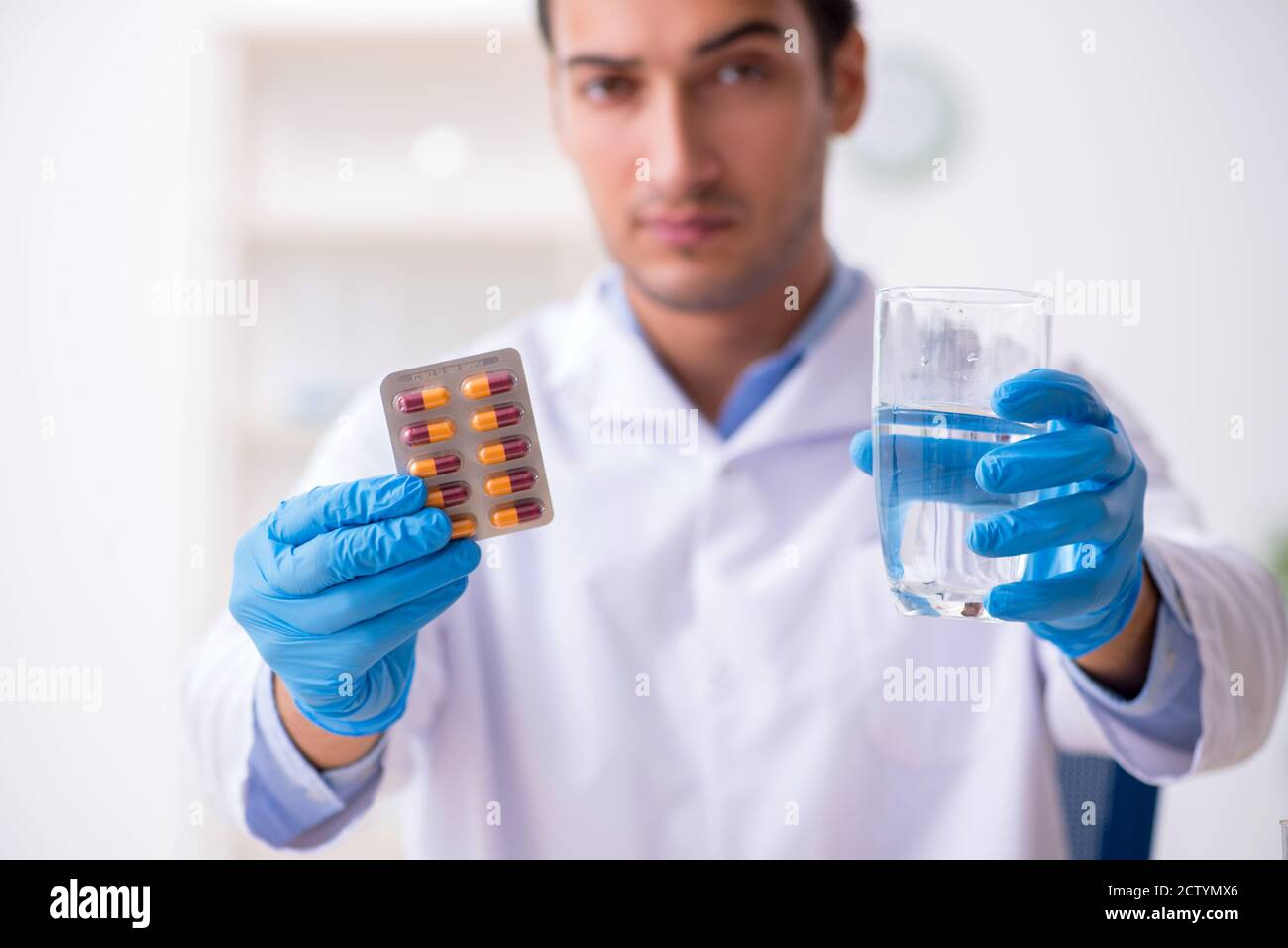 Young male lab assistant in the drug synthesis concept Stock Photo - Alamy