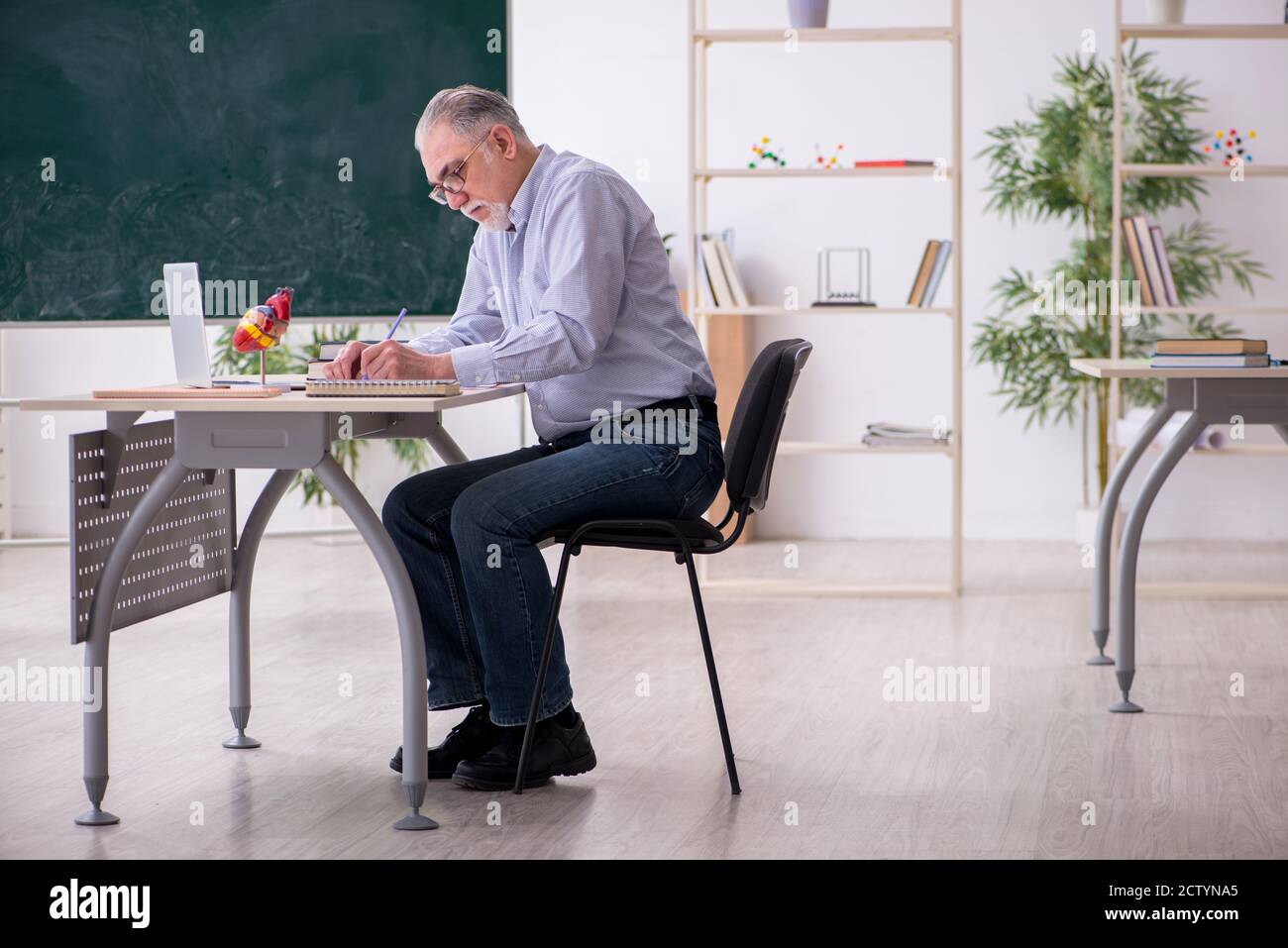 Old male teacher in the school classroom Stock Photo - Alamy