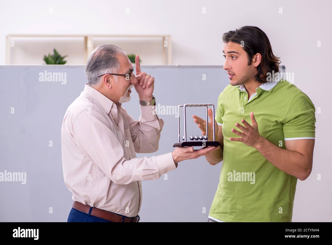 Old professor physicist and student in the classroom Stock Photo - Alamy
