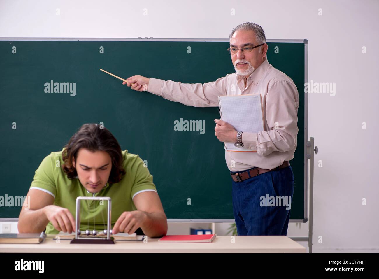 Old professor physicist and student in the classroom Stock Photo - Alamy