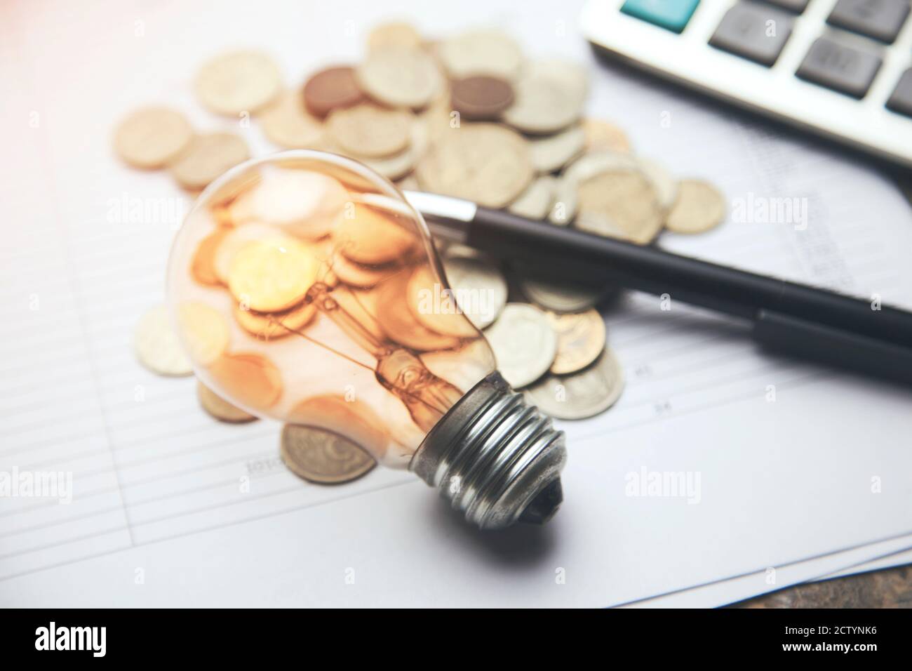 Light bulb on coins hi-res stock photography and images - Alamy