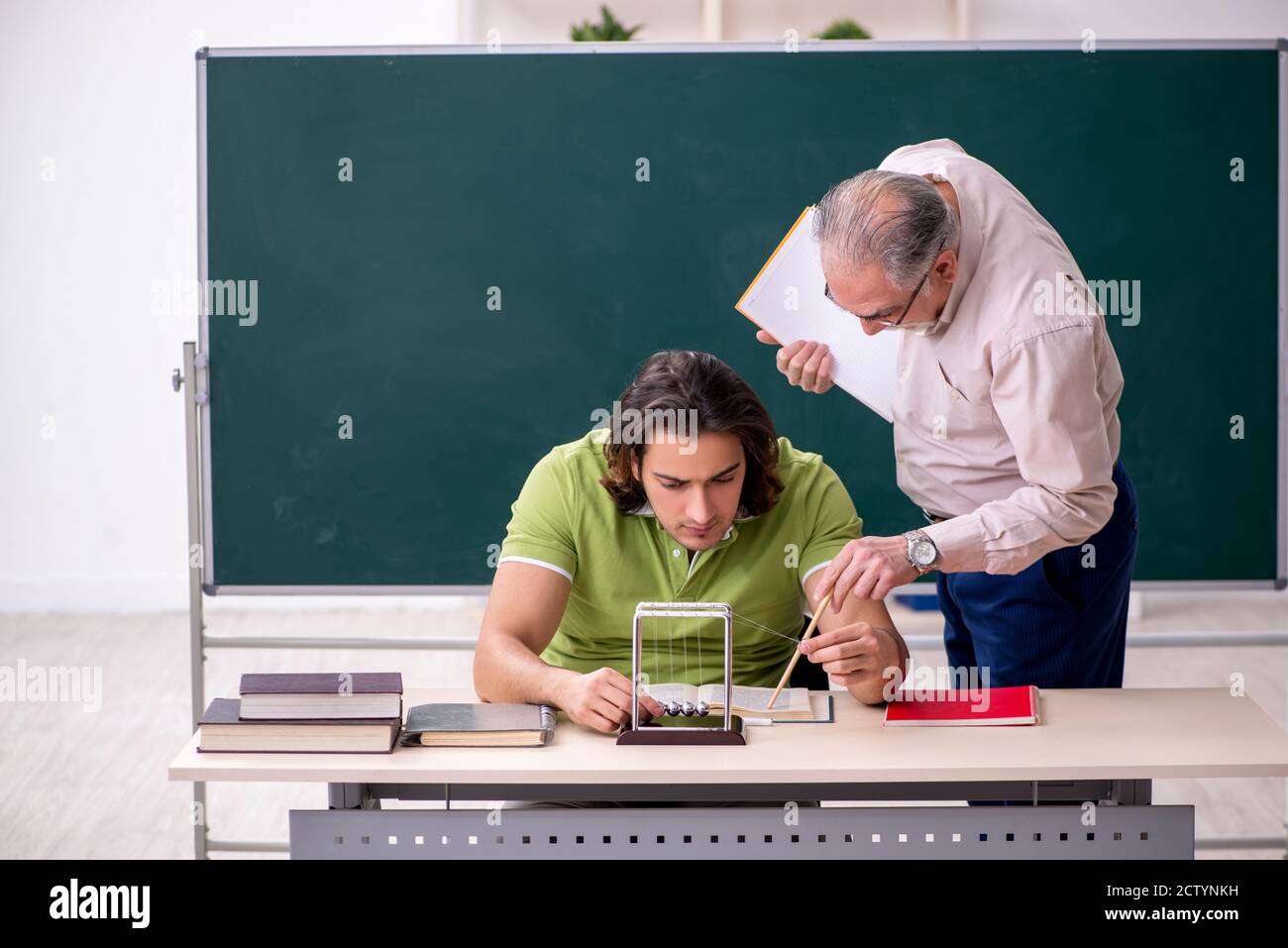 Old professor physicist and student in the classroom Stock Photo - Alamy