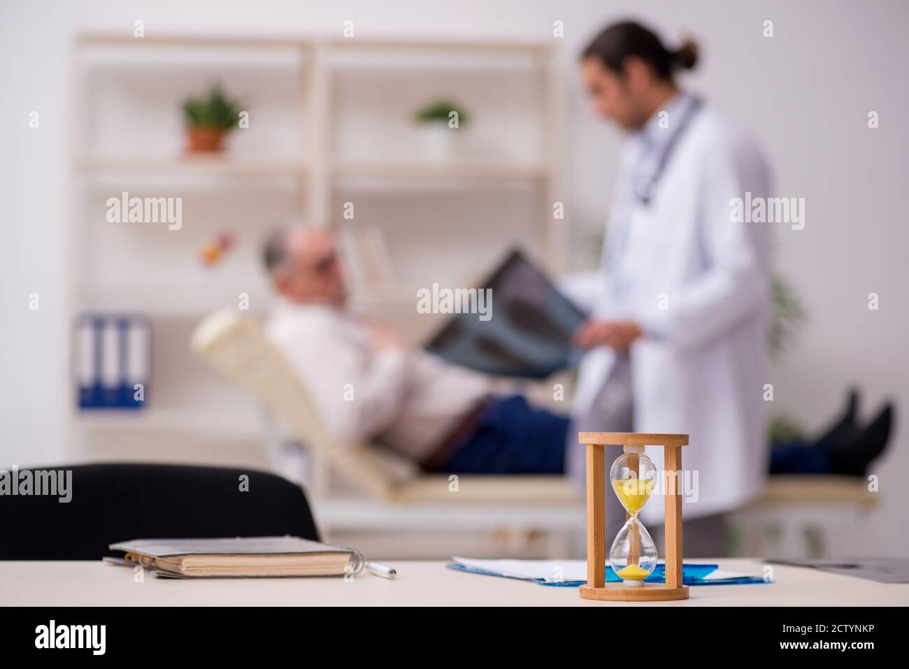 Male patient visiting doctor radiologist in time management concept ...