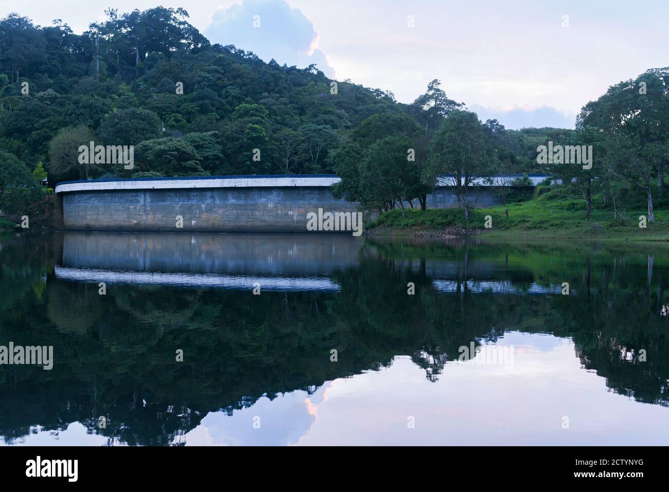 Lush green peak of mountain above foggy valley at Gavi dam Munnar ...