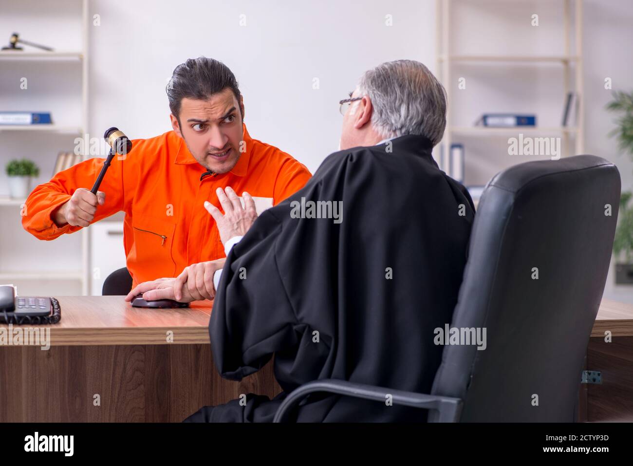 Old judge meeting with young captive in courthouse Stock Photo - Alamy