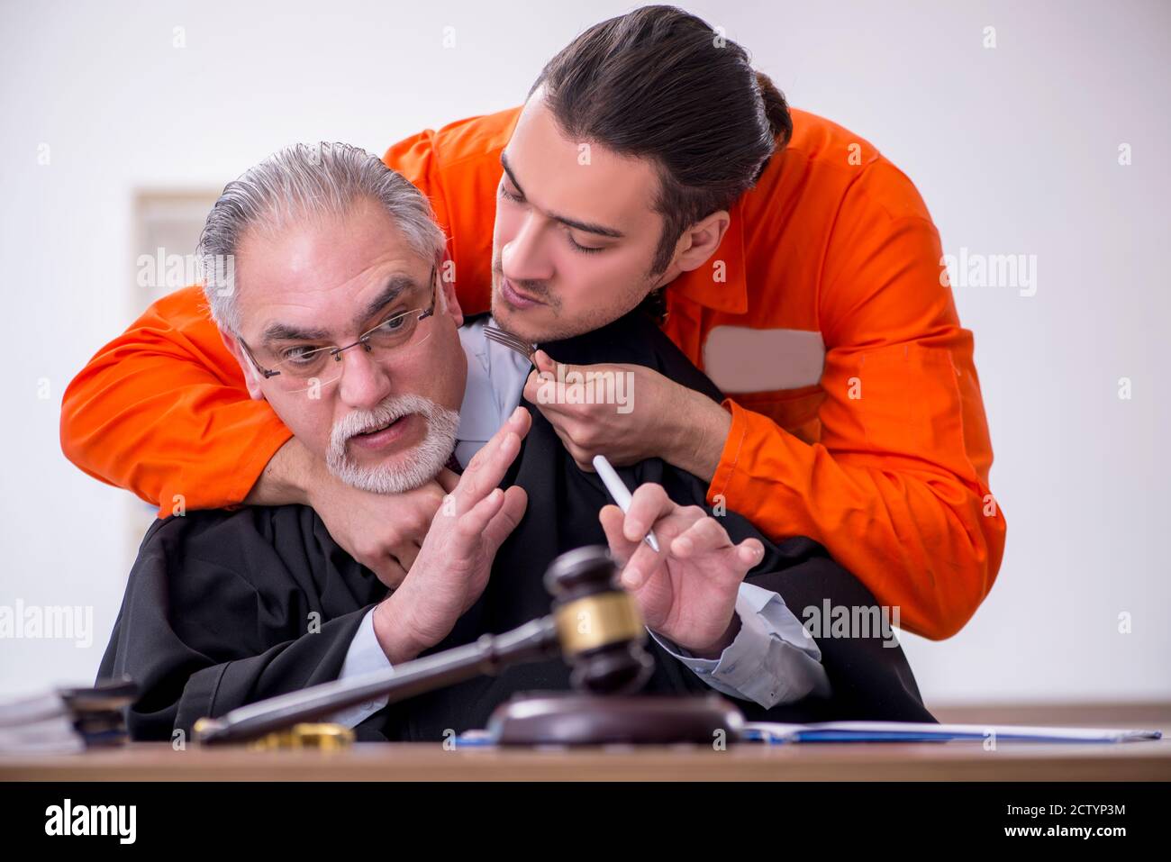 Old judge meeting with young captive in courthouse Stock Photo - Alamy