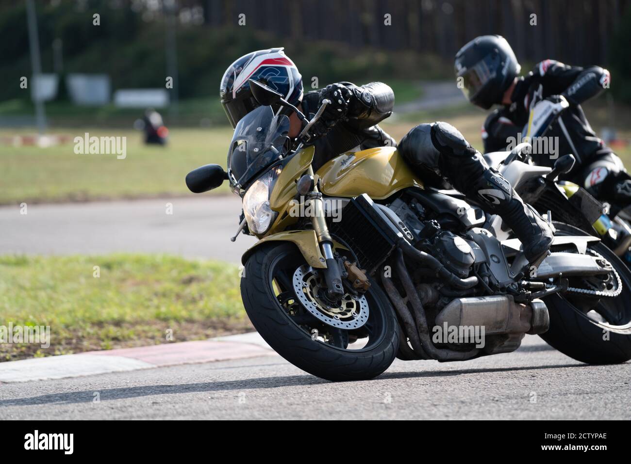 Motorcycle practice leaning into a fast corner on track Stock Photo - Alamy