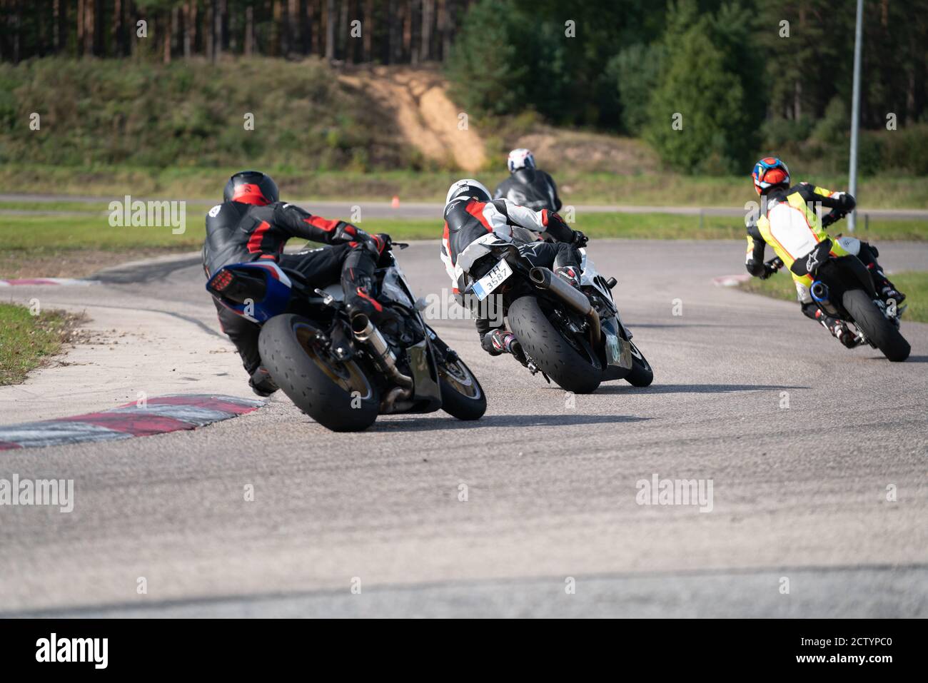 Motorcycle practice leaning into a fast corner on track Stock Photo - Alamy
