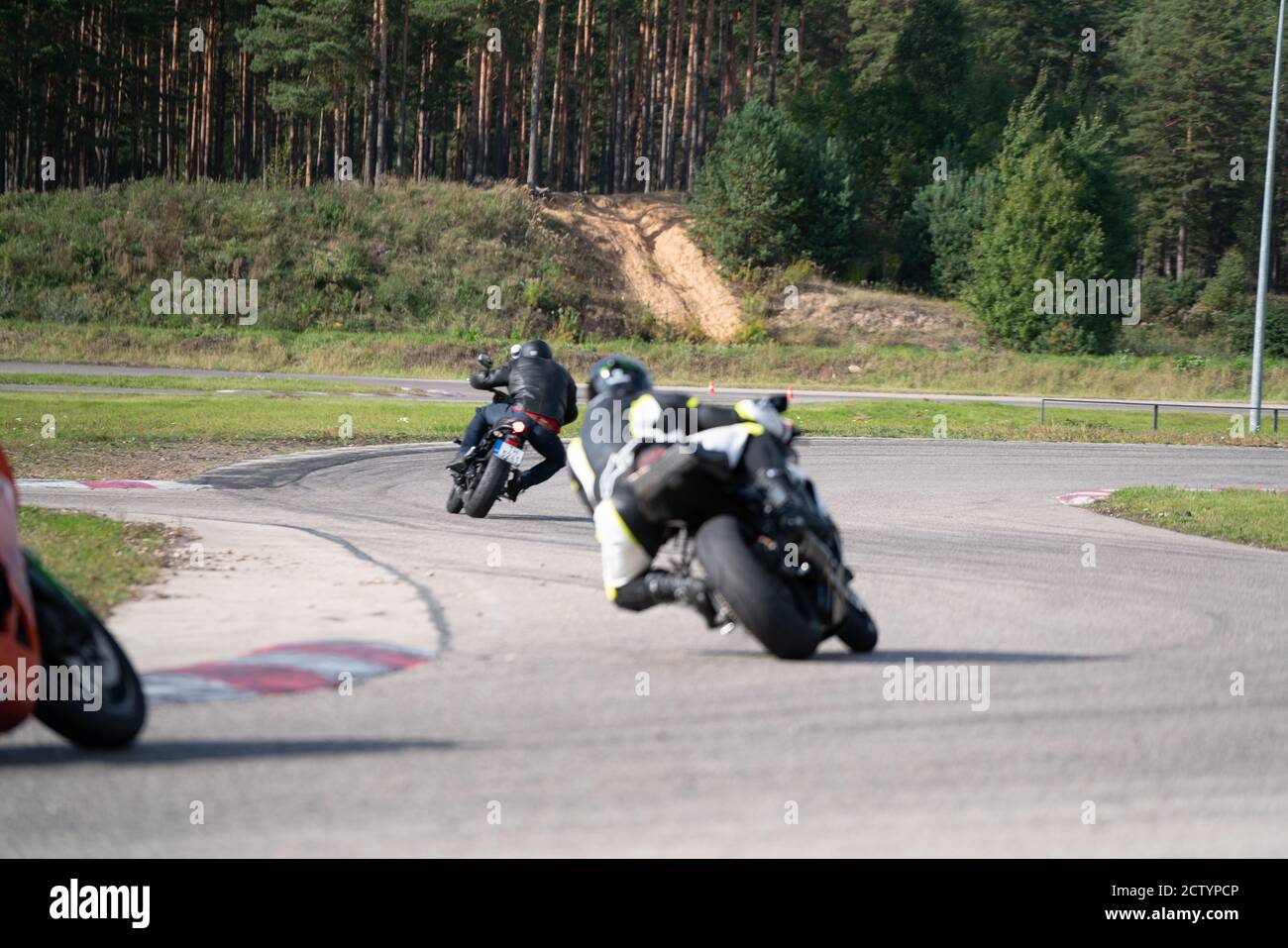 Motorcycle practice leaning into a fast corner on track Stock Photo - Alamy