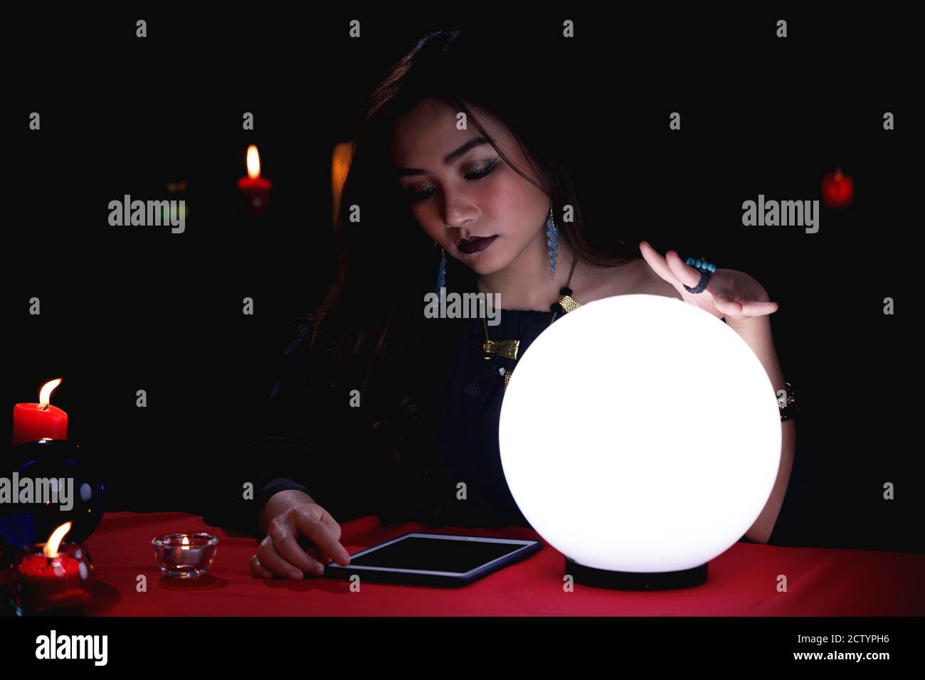 Fortune teller use digital tablet and crystal ball to forecasting ...