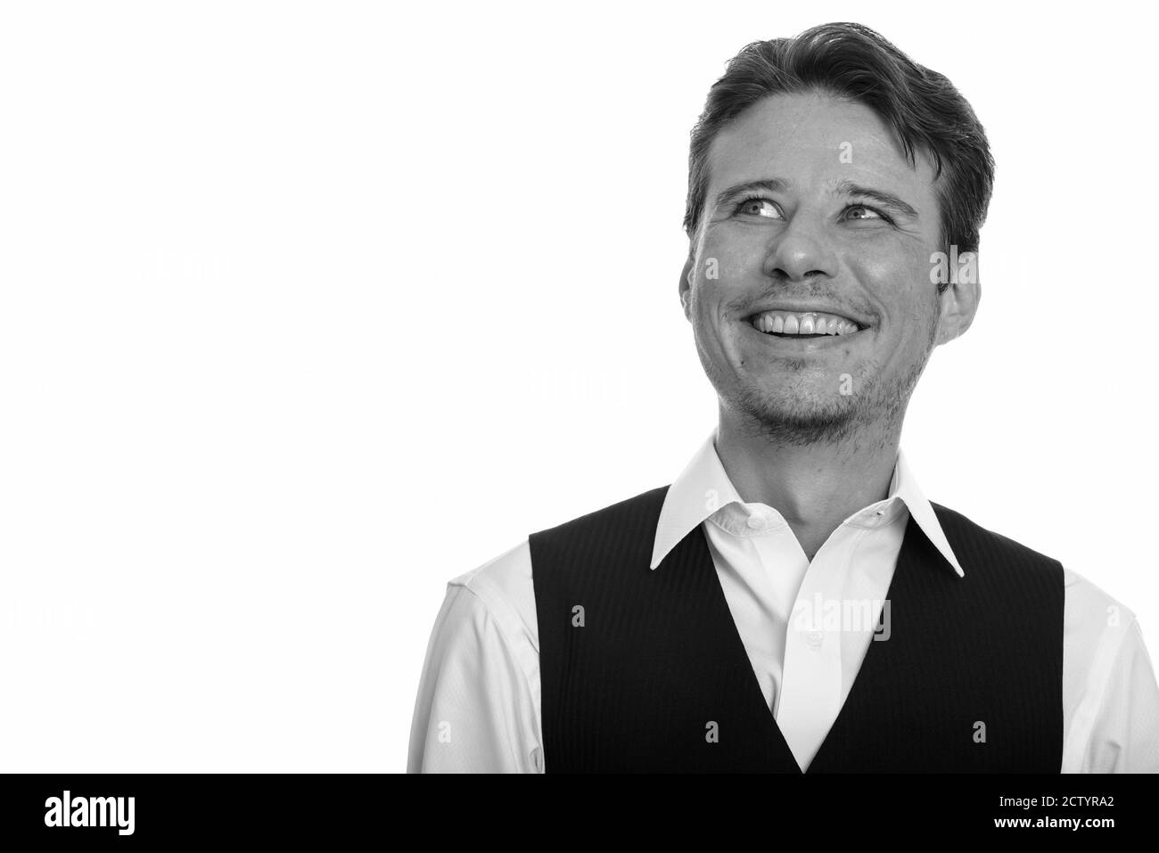 Happy formal Caucasian man thinking wearing vest Stock Photo - Alamy