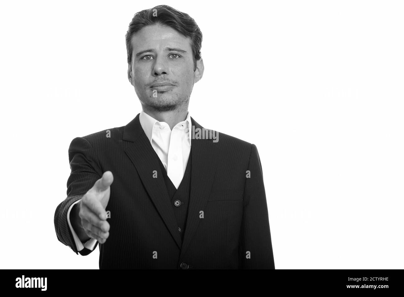 Portrait of handsome businessman in suit giving handshake Stock Photo ...