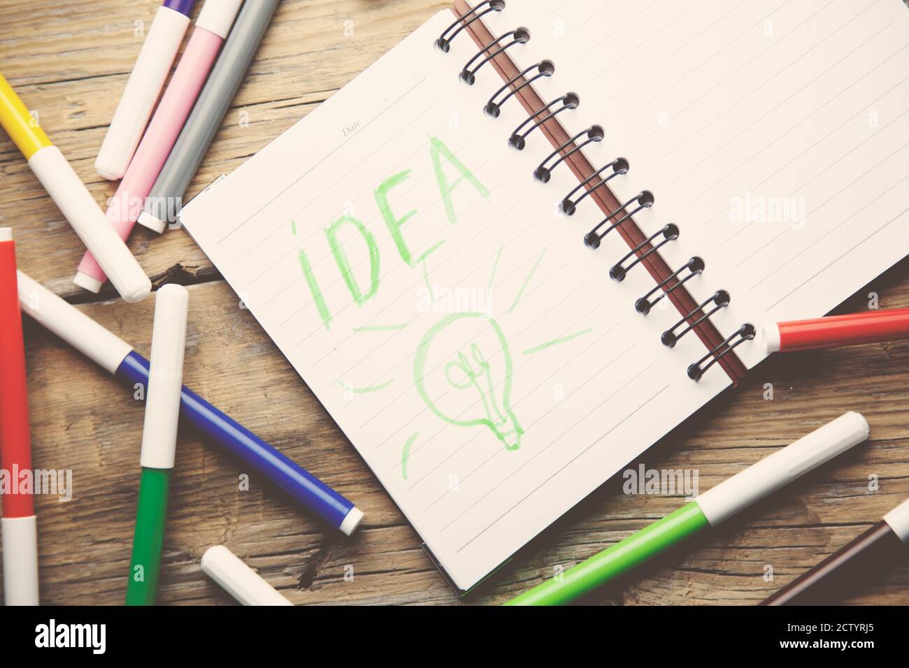 Idea writing on notebook and many colorful markers on wood table Stock ...