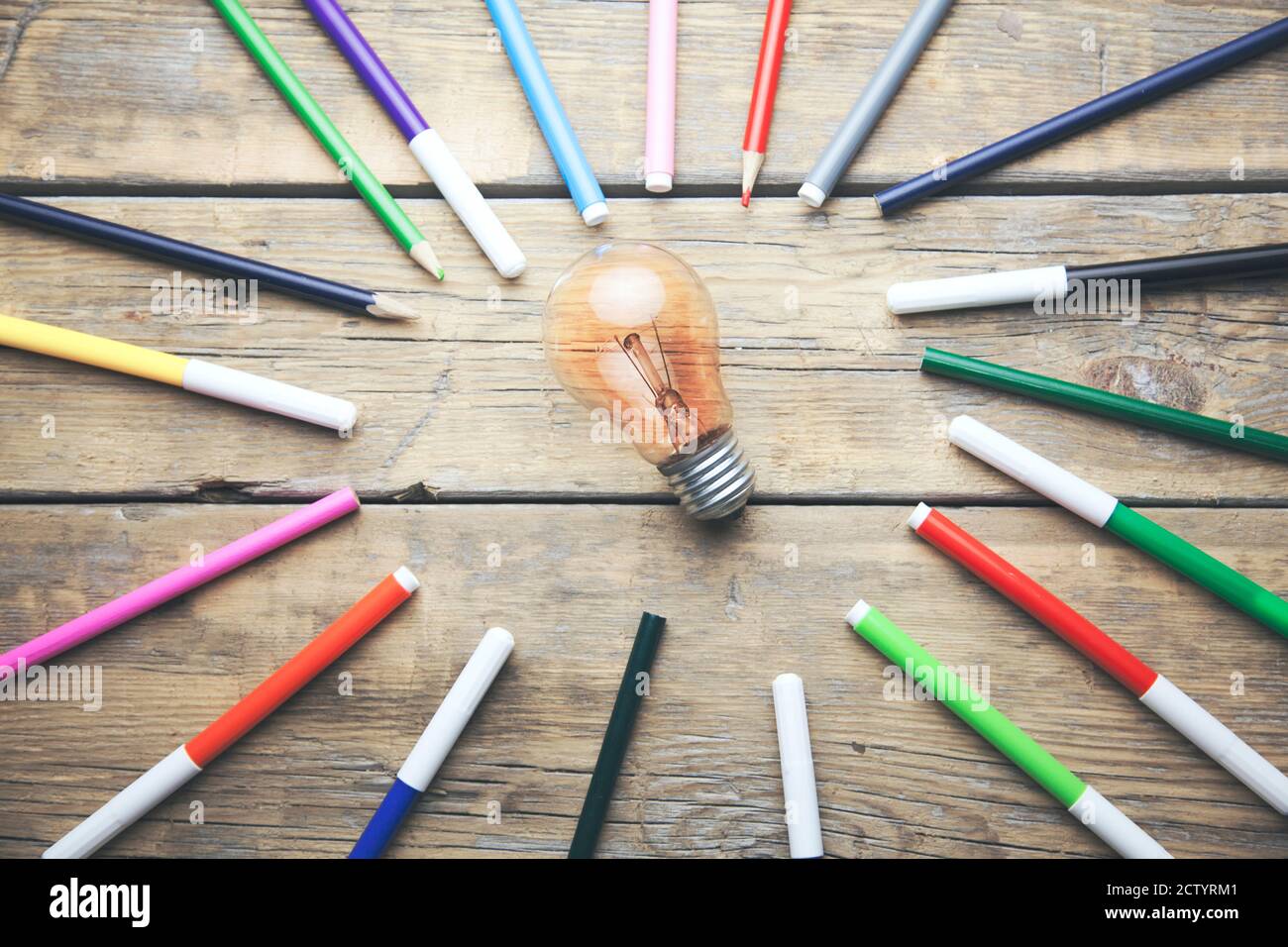 Light bulb with many pencils and markers Stock Photo - Alamy
