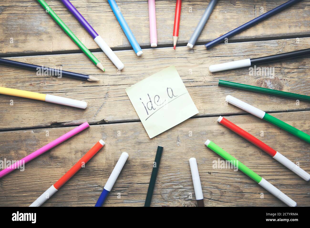 bulb on notebook with many pencils and markers Stock Photo - Alamy