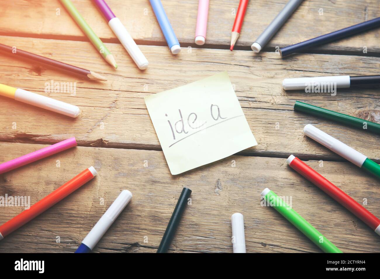 bulb on notebook with many pencils and markers Stock Photo - Alamy