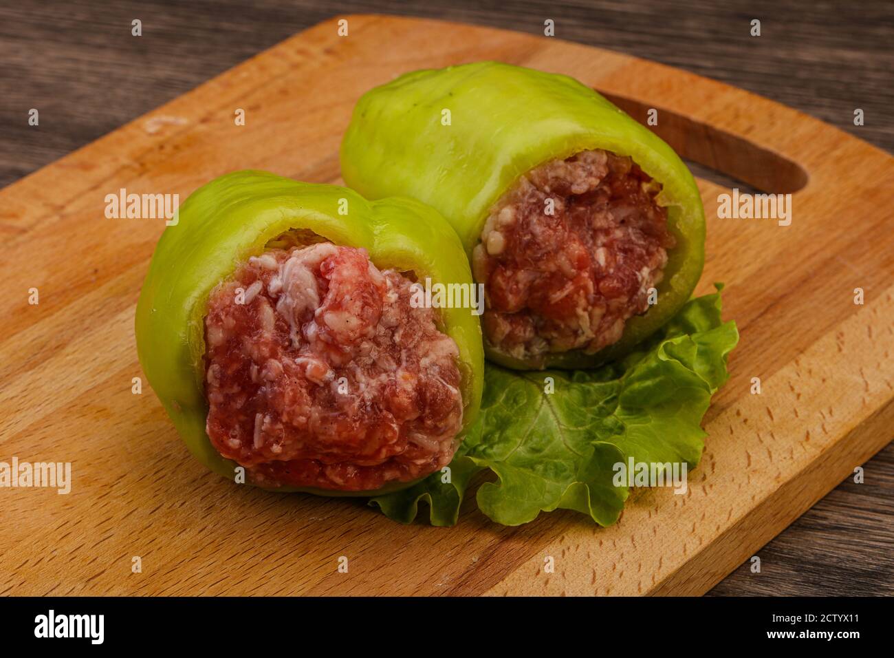 Raw stuffed green bell pepper with meat Stock Photo - Alamy