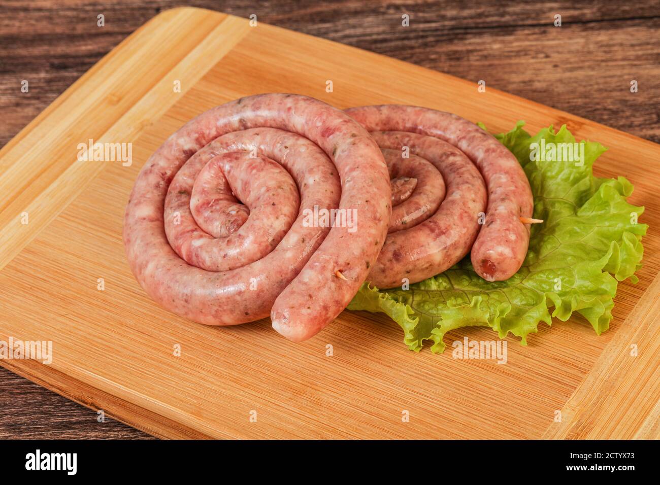 Raw pork sausage ring for grill Stock Photo - Alamy