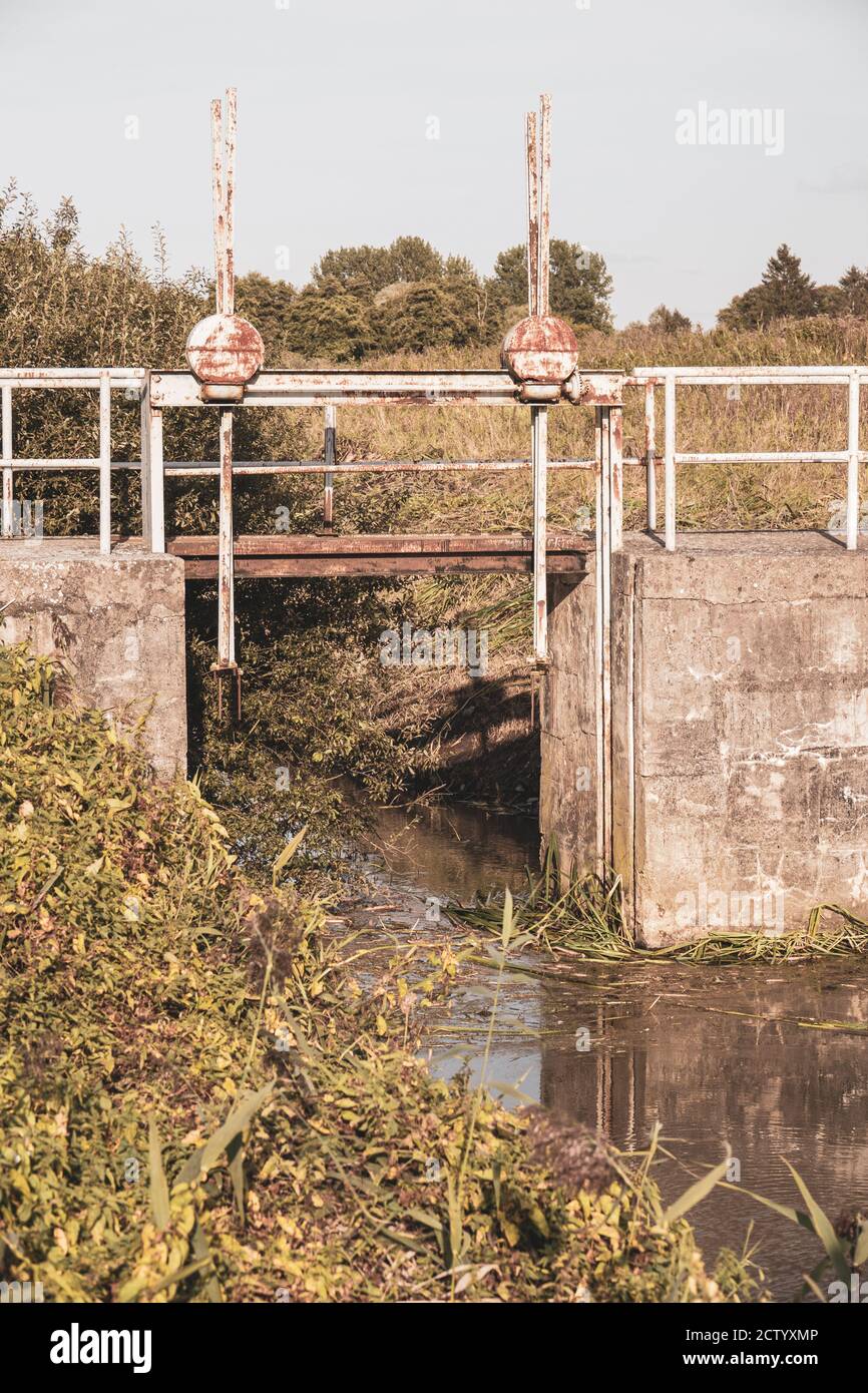 an old rusty lock was used to dam a river Stock Photo - Alamy