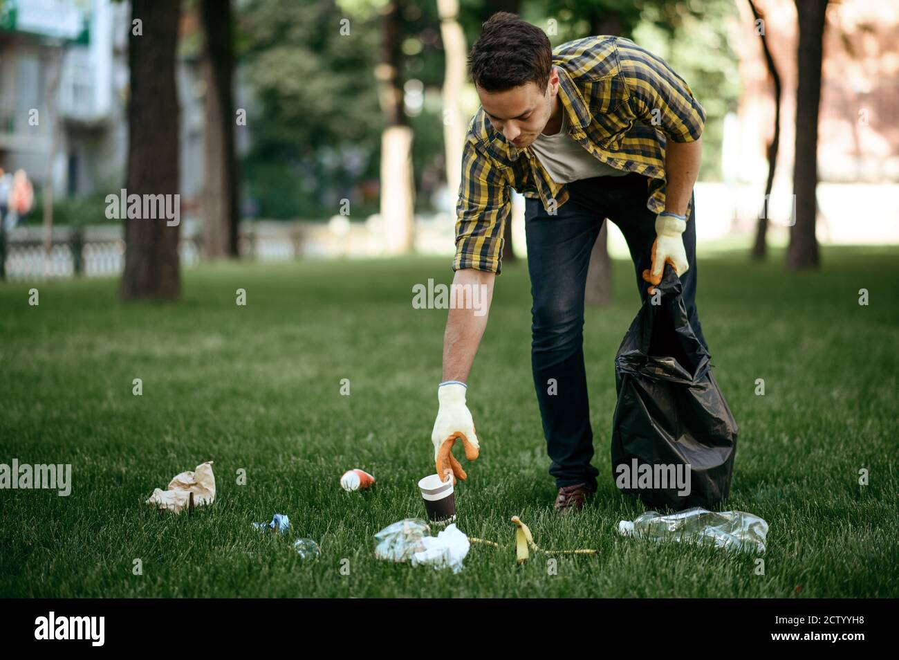 Man collects trash garbage bag hi-res stock photography and images - Alamy