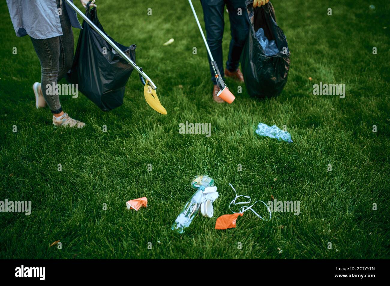 Two men collects plastic garbage, volunteering Stock Photo - Alamy