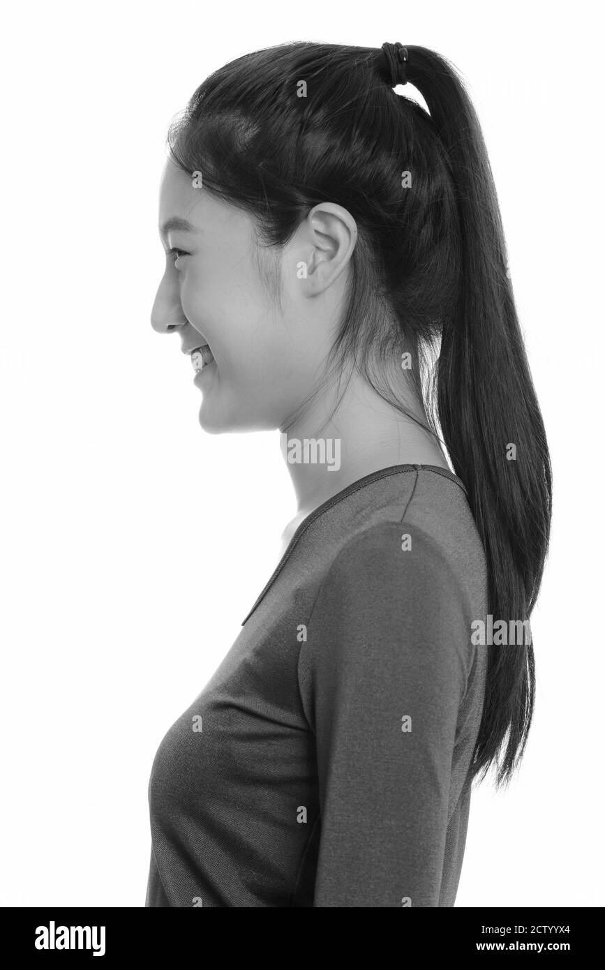 Profile view of young happy Asian teenage girl smiling Stock Photo - Alamy